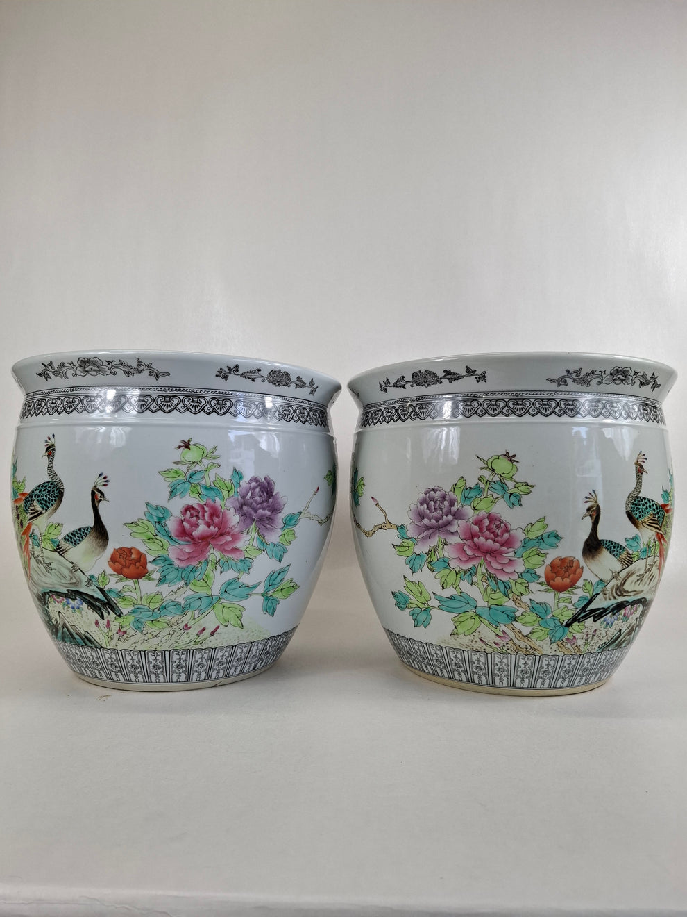 Pair of large Chinese fencai planters decorated with flowers and peaco ...